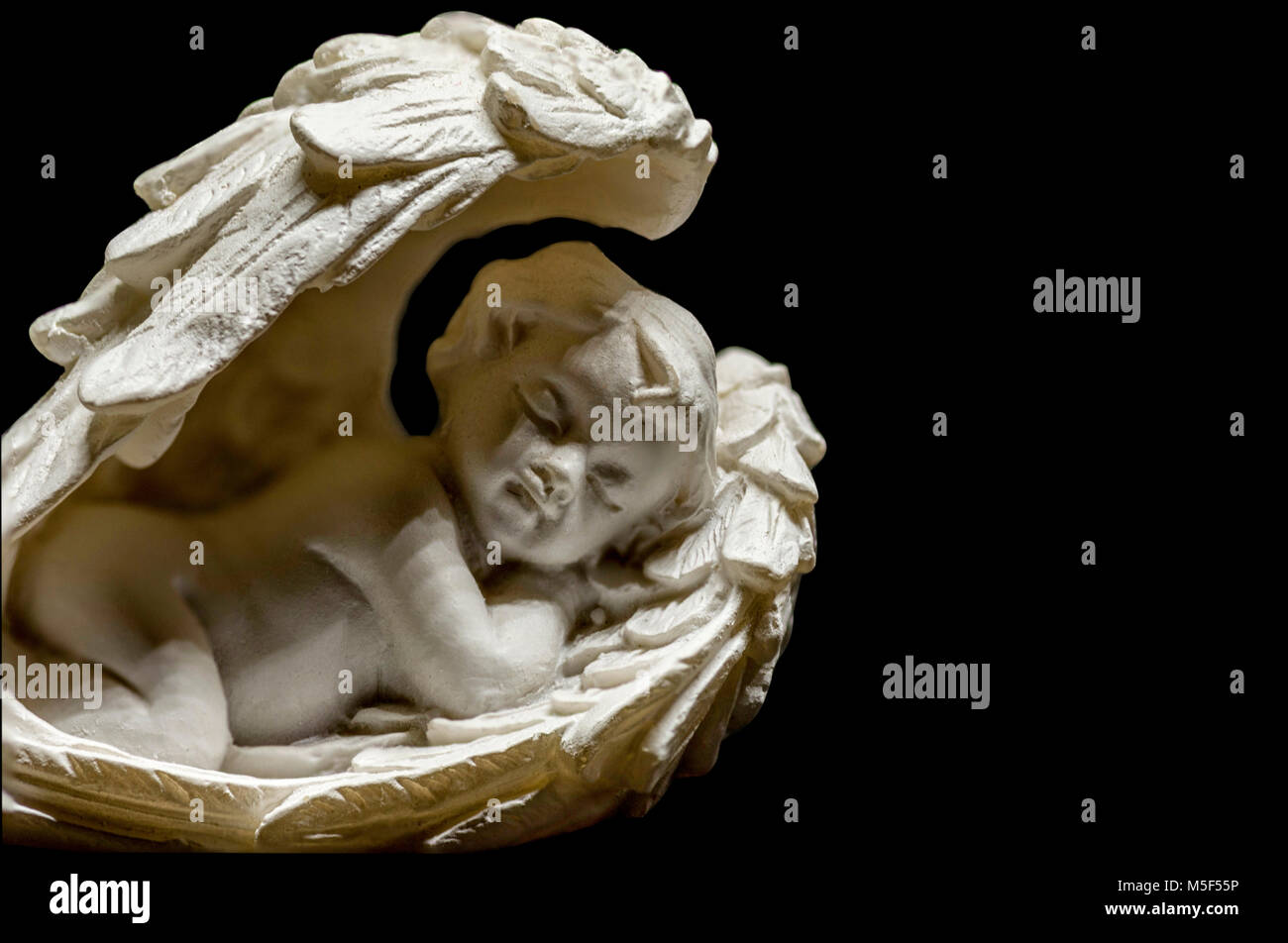 little angel is sleeping inside his wings Stock Photo - Alamy