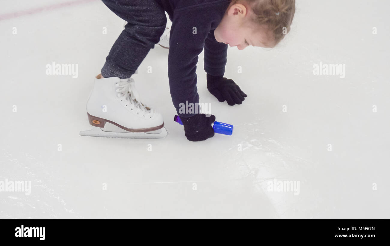 Little girl drawing with marker on ice on indorr ice skating rink Stock ...