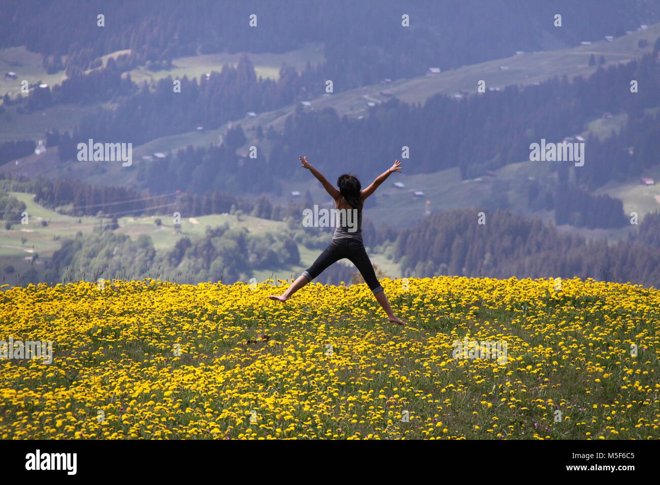 a girl between flowers Stock Photo - Alamy