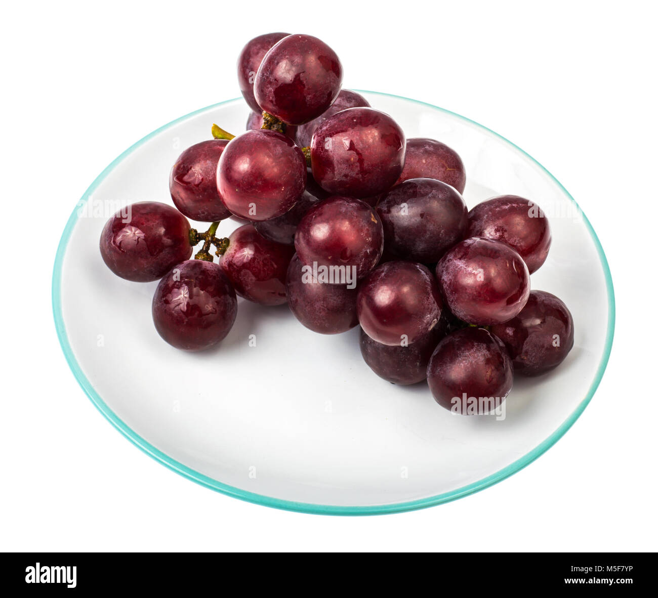 Bunch of red grapes on plate. Studio Photo Stock Photo - Alamy