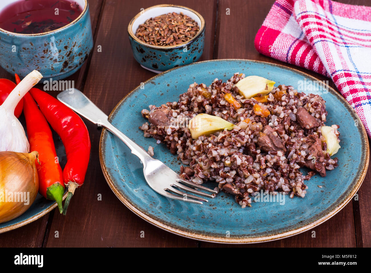 Garnish of red rice, garlic, vegetables, chicken meat. Studio Photo ...