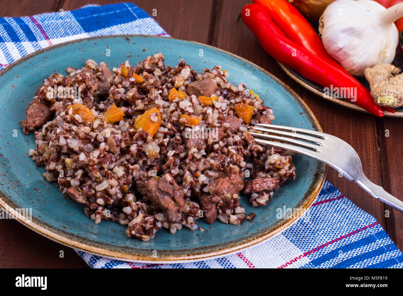 Garnish of red rice, garlic, vegetables, chicken meat. Studio Photo ...
