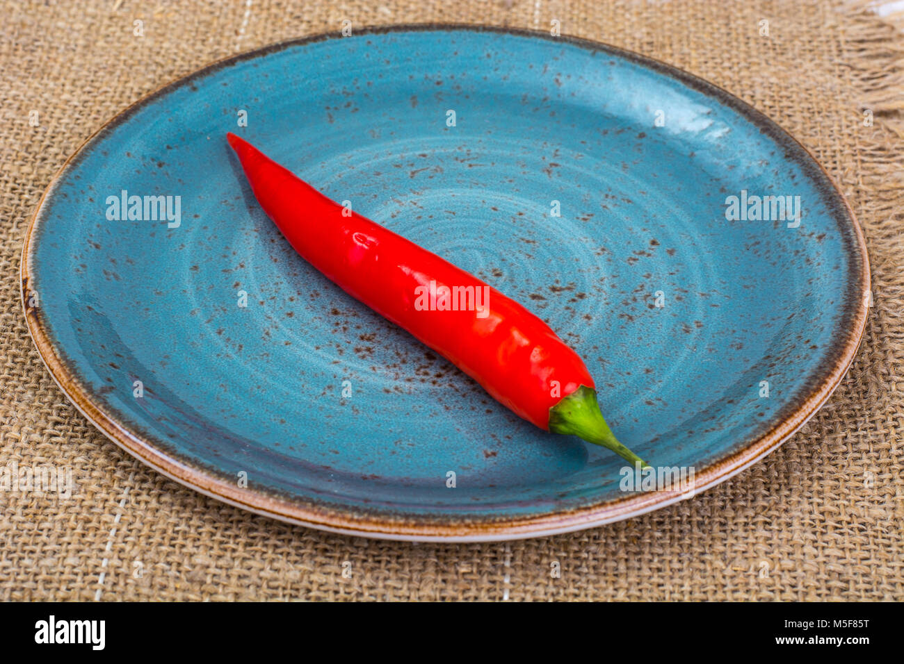 Pod of red chili peppers on fabric background. Studio Photo Stock Photo ...