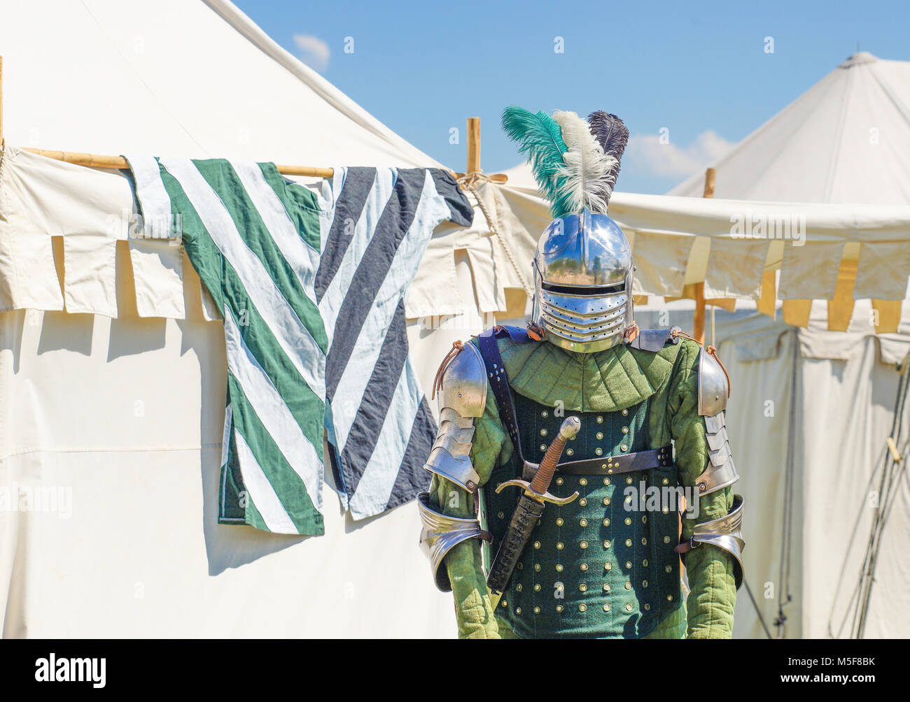 Empty knight's armour in front of white tents in the background Stock ...