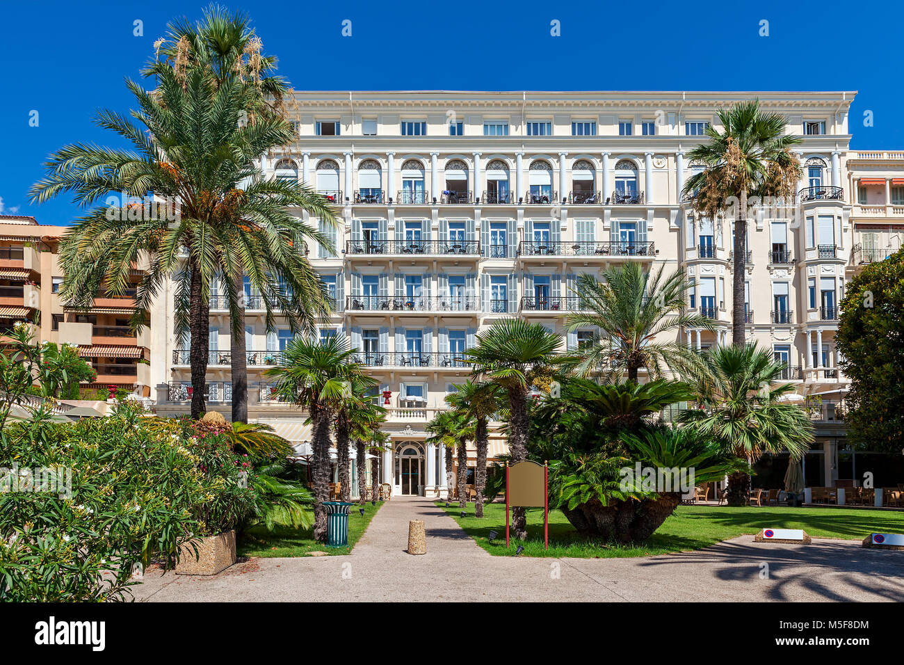 Front view of luxury hotel in small town of Menton on French Riviera ...