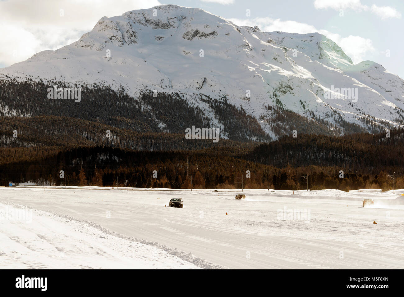A panorama view of snowy landscape and mountains and cars on the snow ...