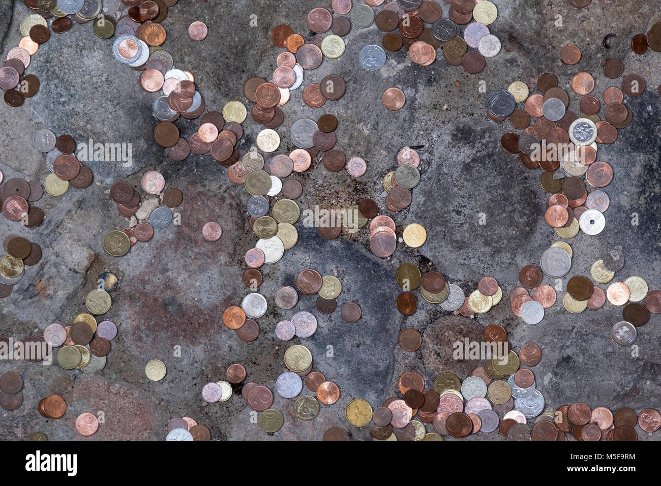 Colorful lCoins Spreaded to Rock Floor Stock Photo - Alamy