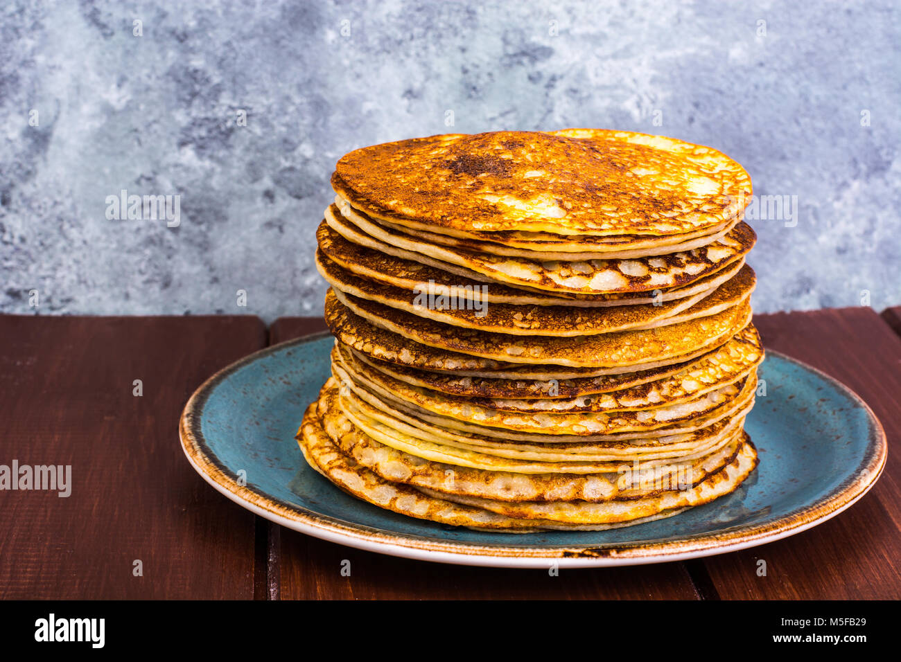 High stack of hot pancakes on wooden table. Studio Photo Stock Photo ...