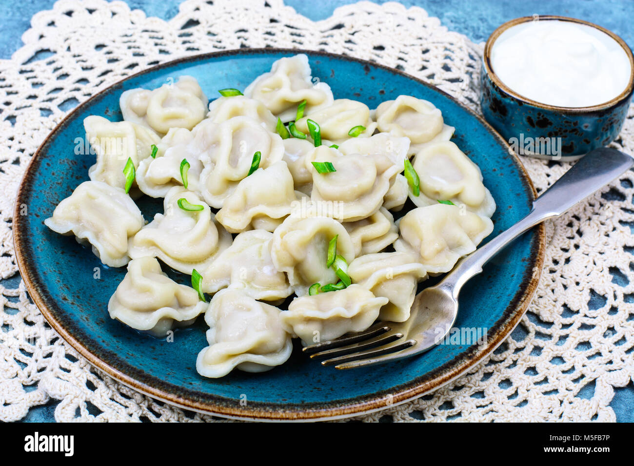 Delicious cooked ravioli on blue plate. Studio Photo Stock Photo - Alamy
