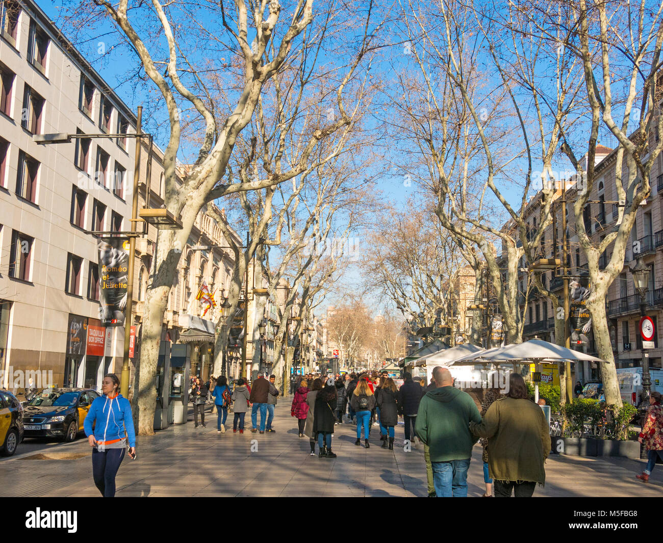 The famous Ramblas street with walking tourists. Thousands of people ...