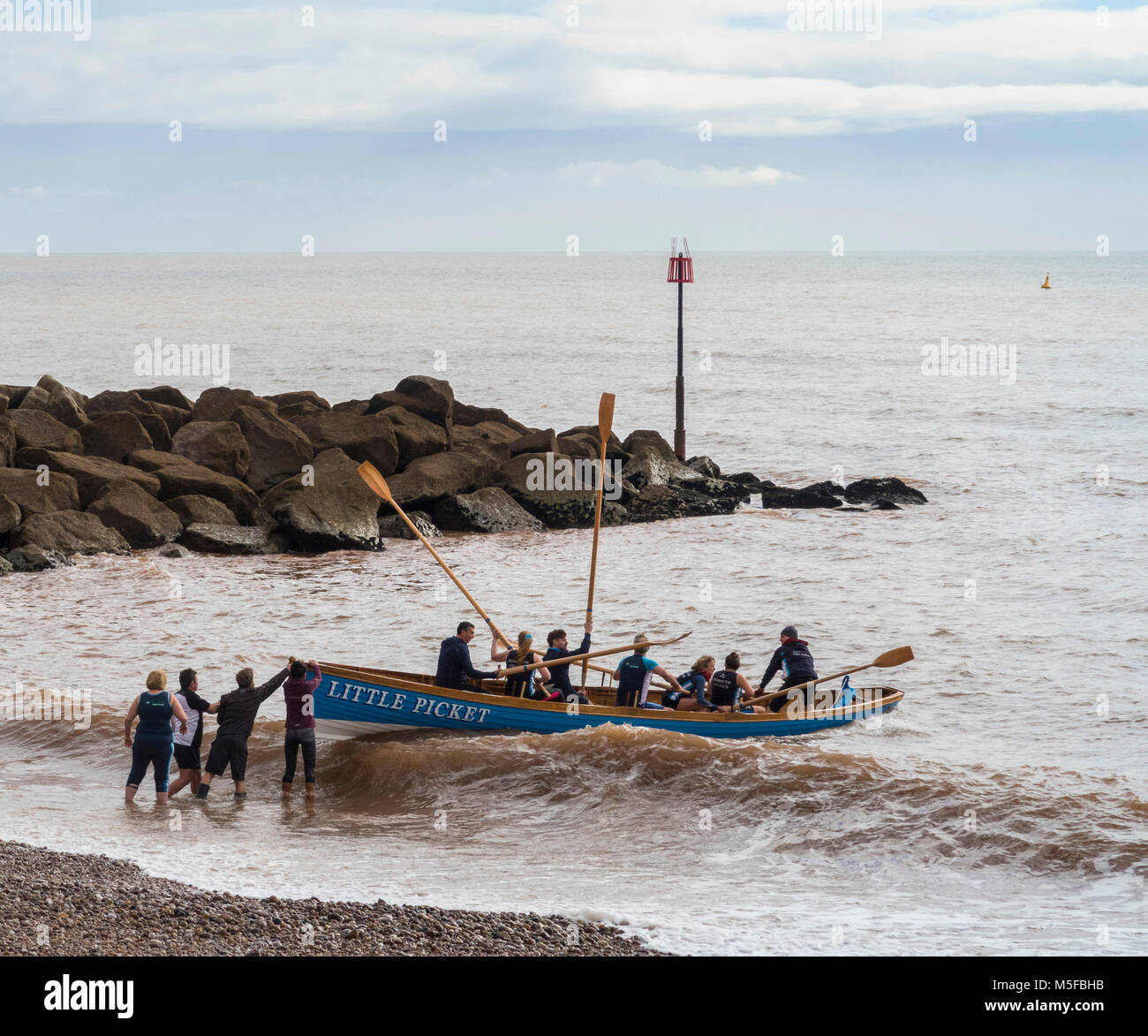 Launching a new Pilot Gig boat the "Little Picket" at Sidmouth, Devon ...