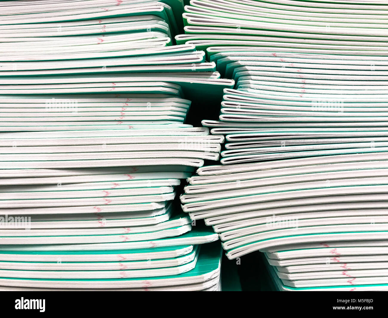 Pile of school notebooks on shelf. Studio Photo Stock Photo - Alamy