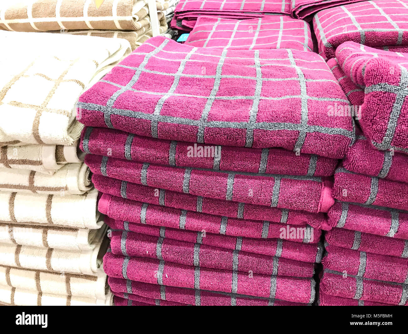 Stacks of colored terry towel on shelves. Studio Photo Stock Photo - Alamy