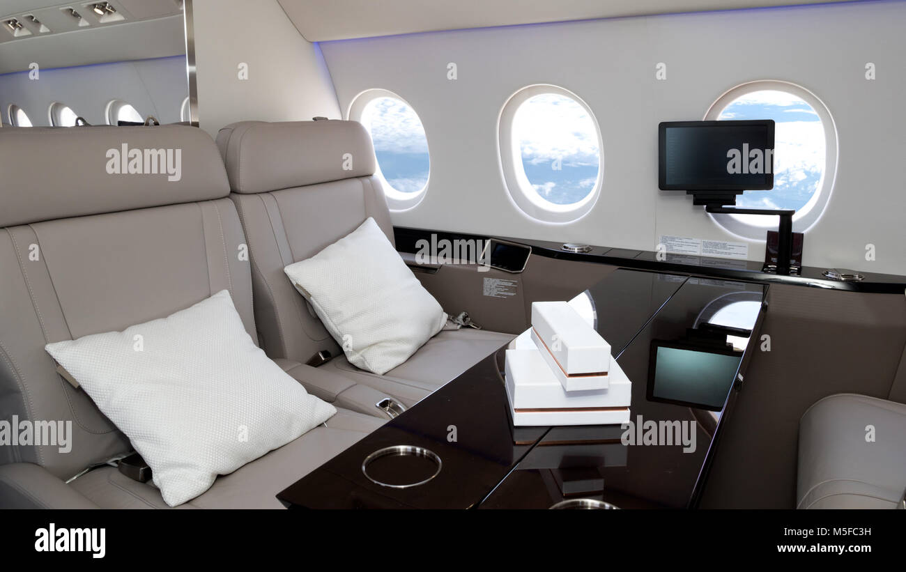 Comfortible cabin chair in a modern business jet aircraft during flight ...