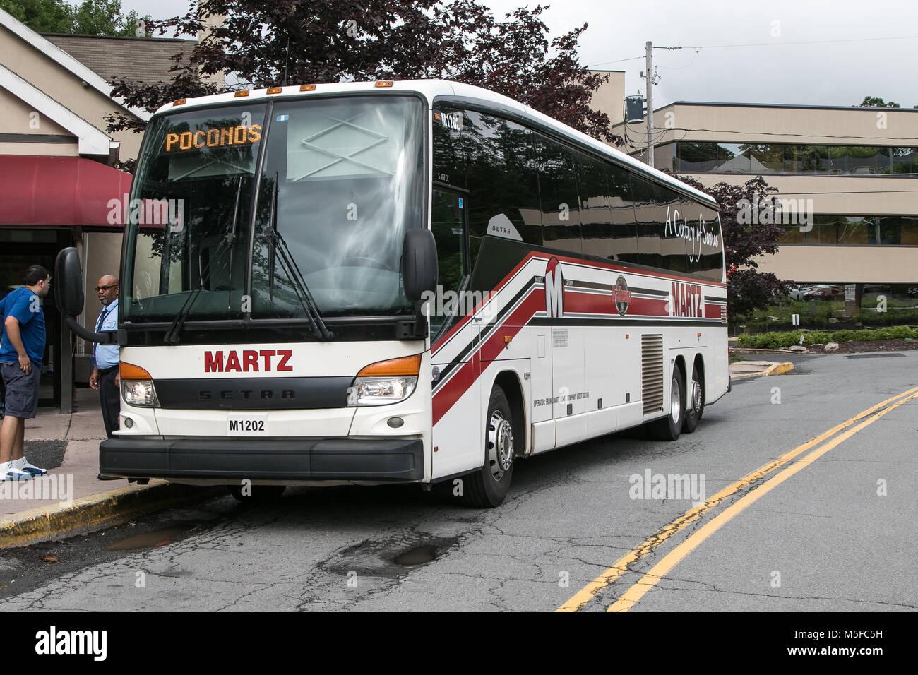 Martz bus is parked at the station as passengers board it Stock Photo ...