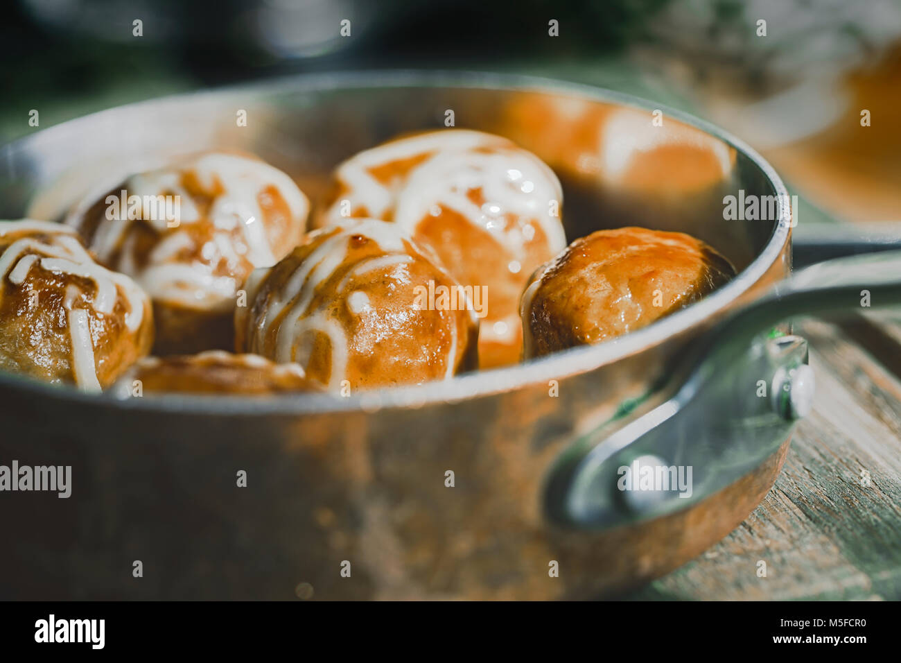 Meatballs in creamy sauce on a copper frying pan Stock Photo - Alamy