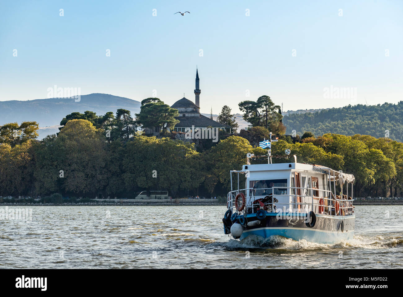 Ferry boat on Lake Pamvotidha with the Aslan Pasha Mosque in the ...