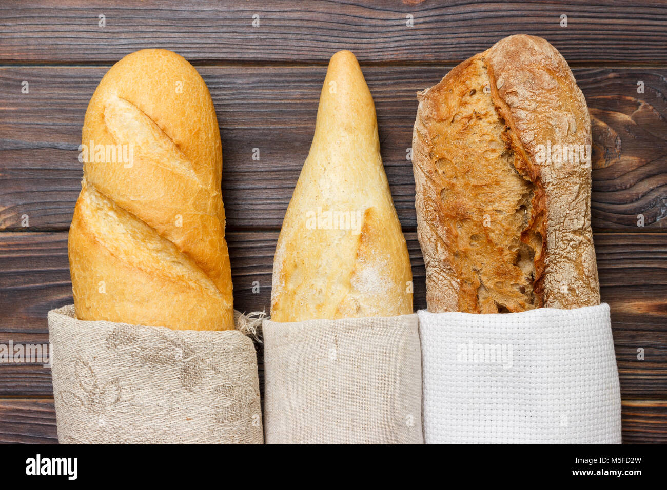 Loaf of bread in a bag european style on a rustic table Stock Photo - Alamy