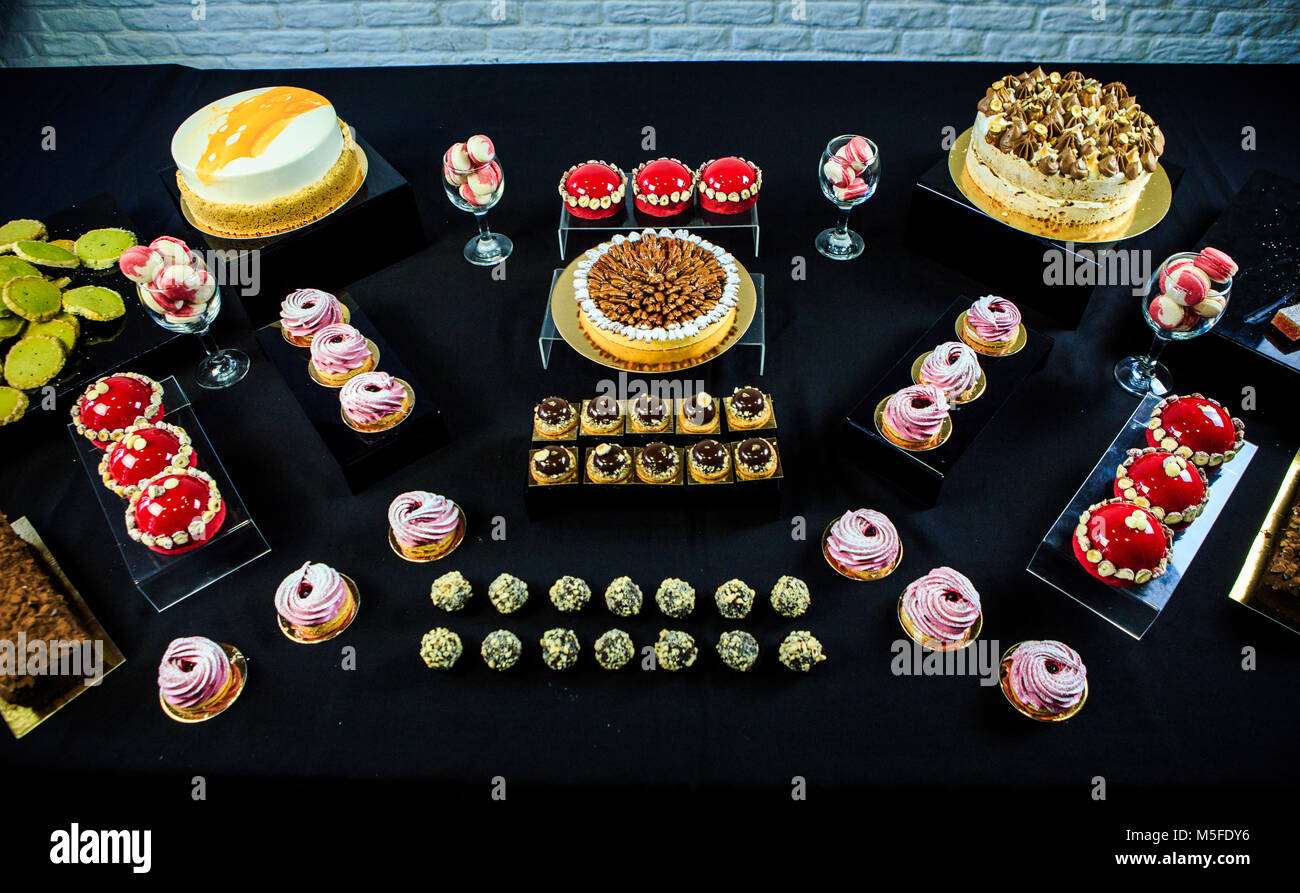 numerous colorful assorted sweets arranged on black background Stock ...