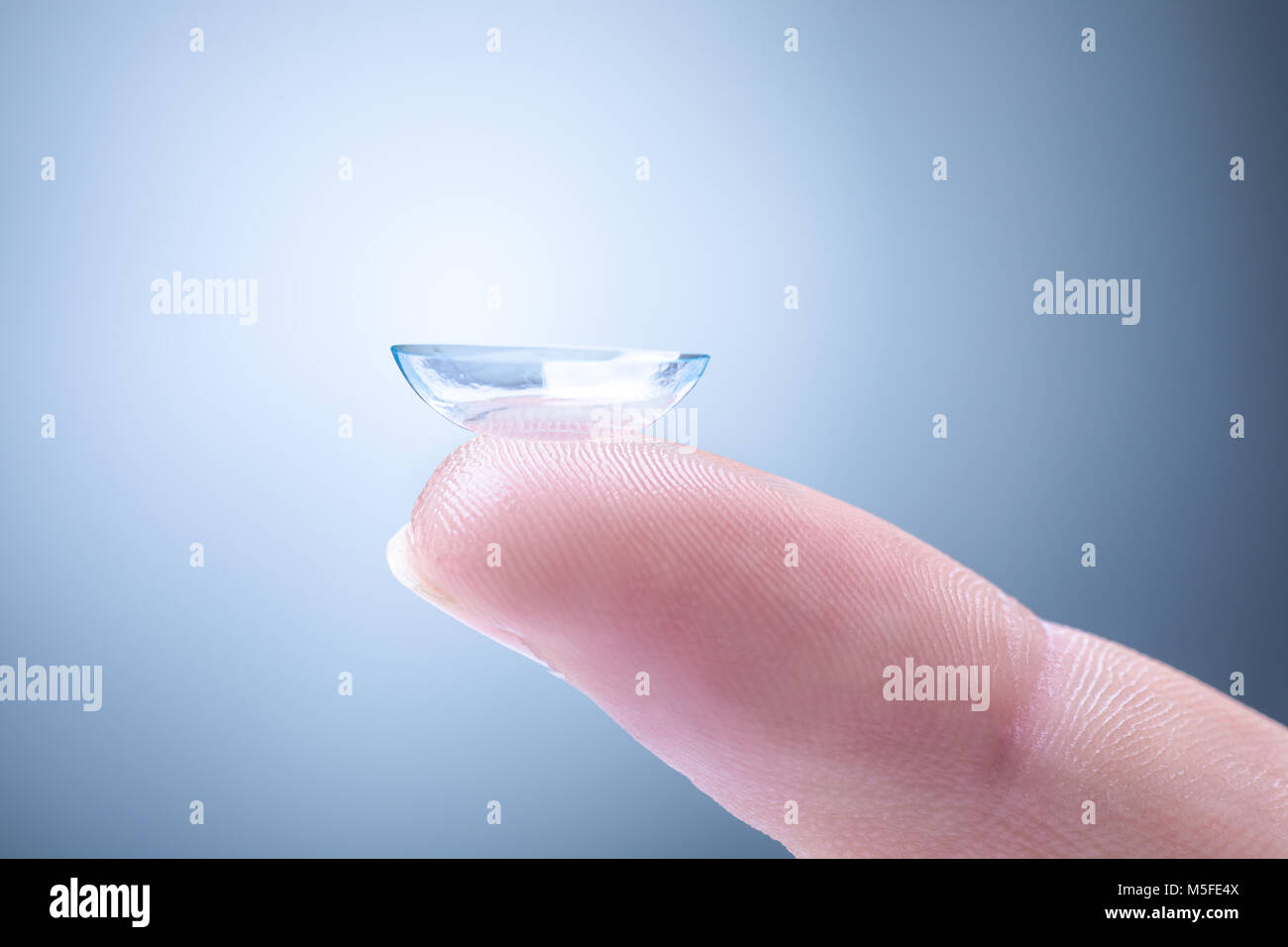 Contact Lens on a Man's Index Finger Stock Photo - Alamy