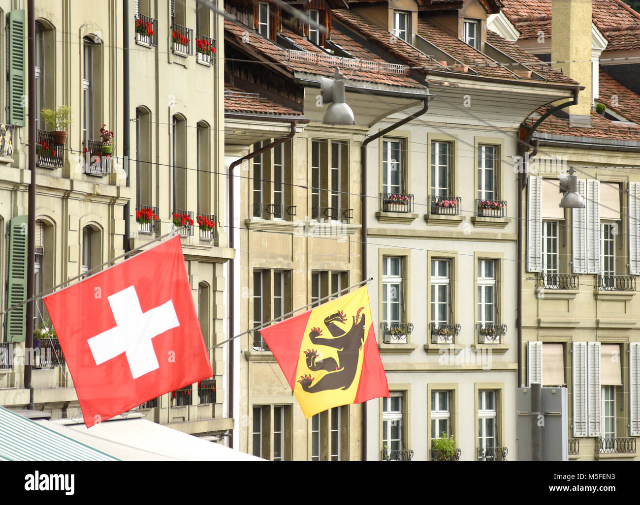 Swiss flag and flag of Bern on the facade building in Bern, Switzerland ...