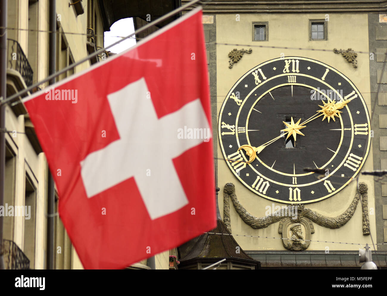 Swiss flag front of the famous clock tower in Bern, Switzerland Stock ...