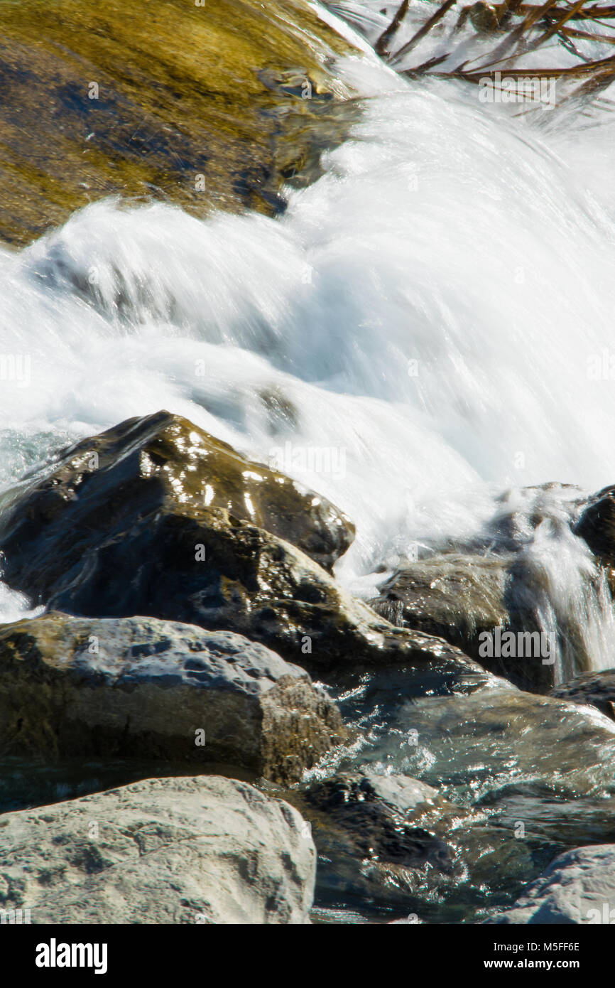 Natural background of flowing water in the golden river Stock Photo - Alamy