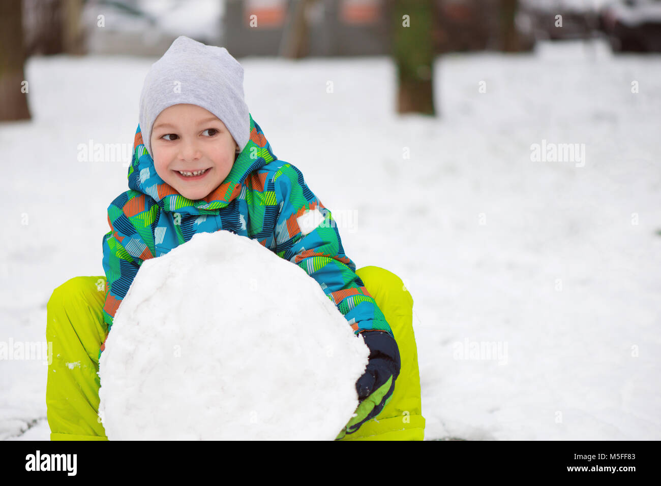 Children throwing snowballs in snowy winter park Stock Photo - Alamy