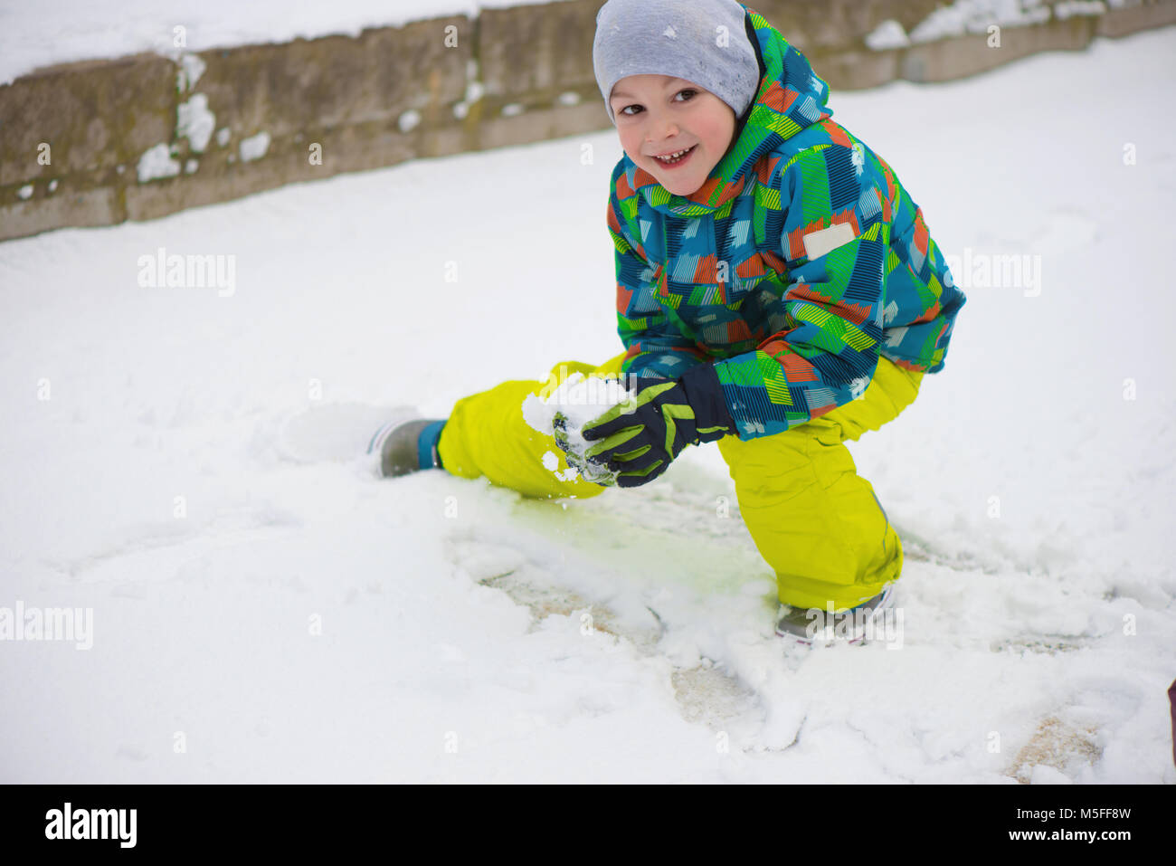 Children throwing snowballs in snowy winter park Stock Photo - Alamy