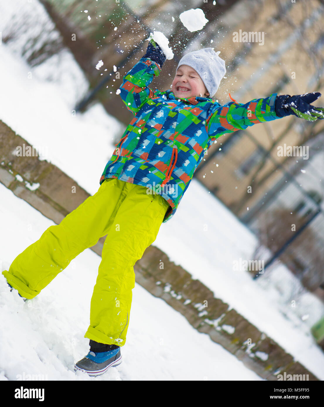 Children throwing snowballs in snowy winter park Stock Photo - Alamy