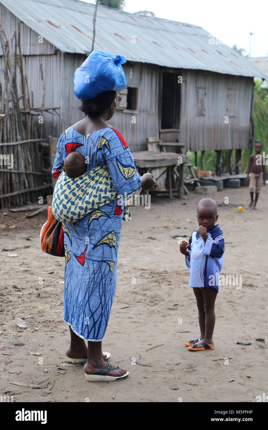 Woman with her children, baby on her back Stock Photo - Alamy