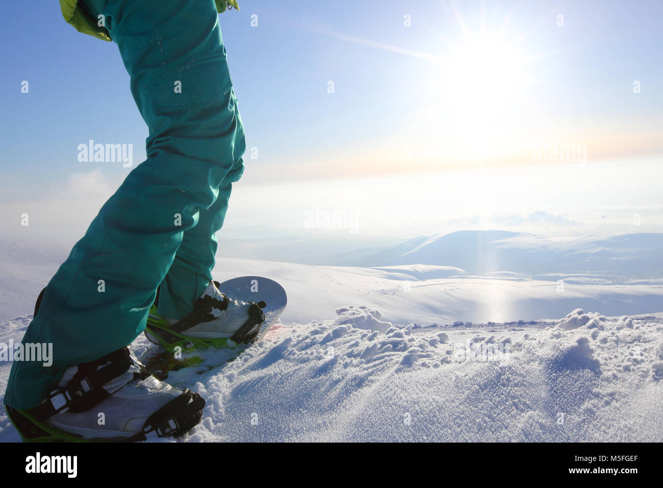 Snowboarder riding on slope at ski resort at sunny day Stock Photo - Alamy
