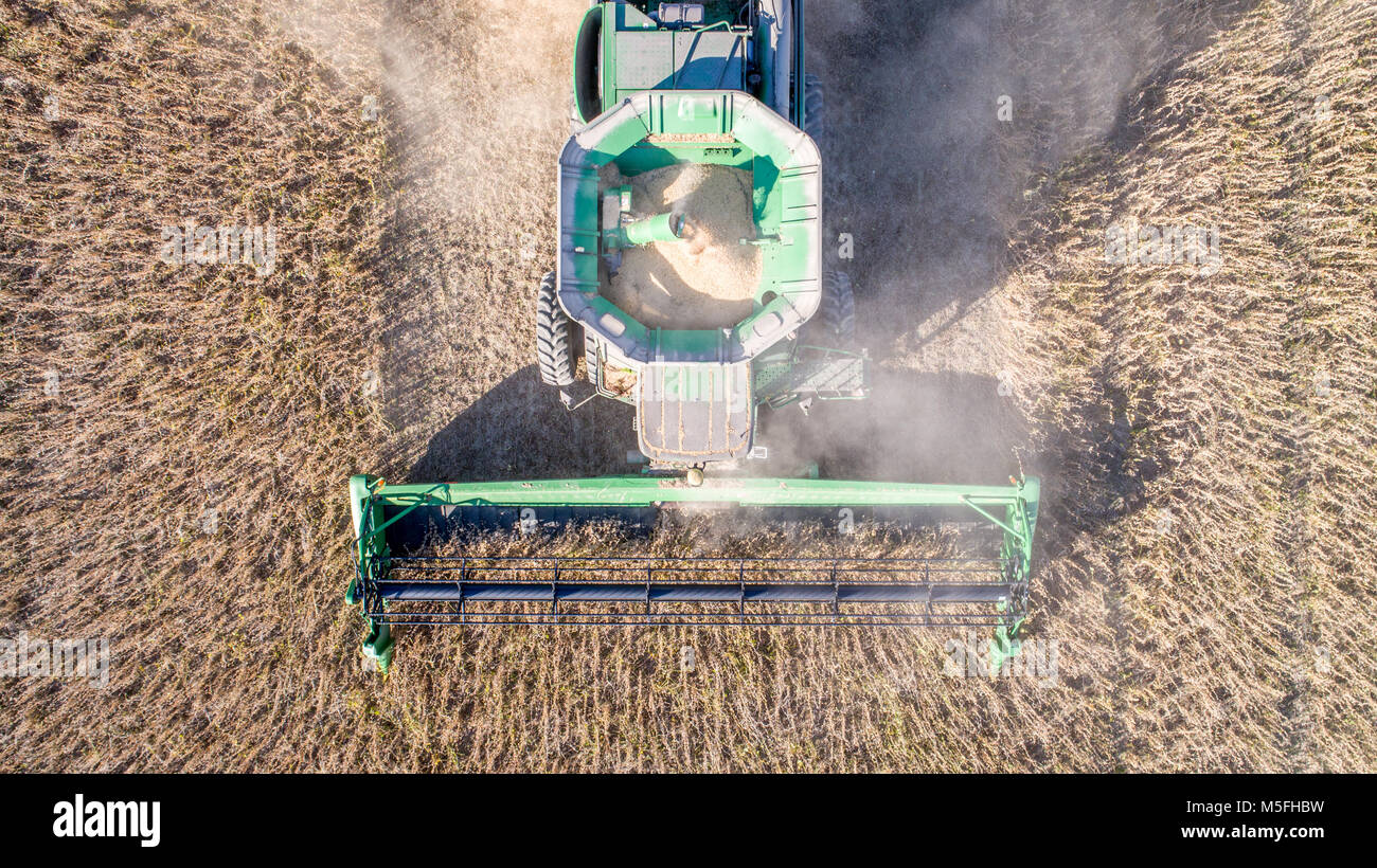 Aerial view looking directly down at a combine harvester driving ...