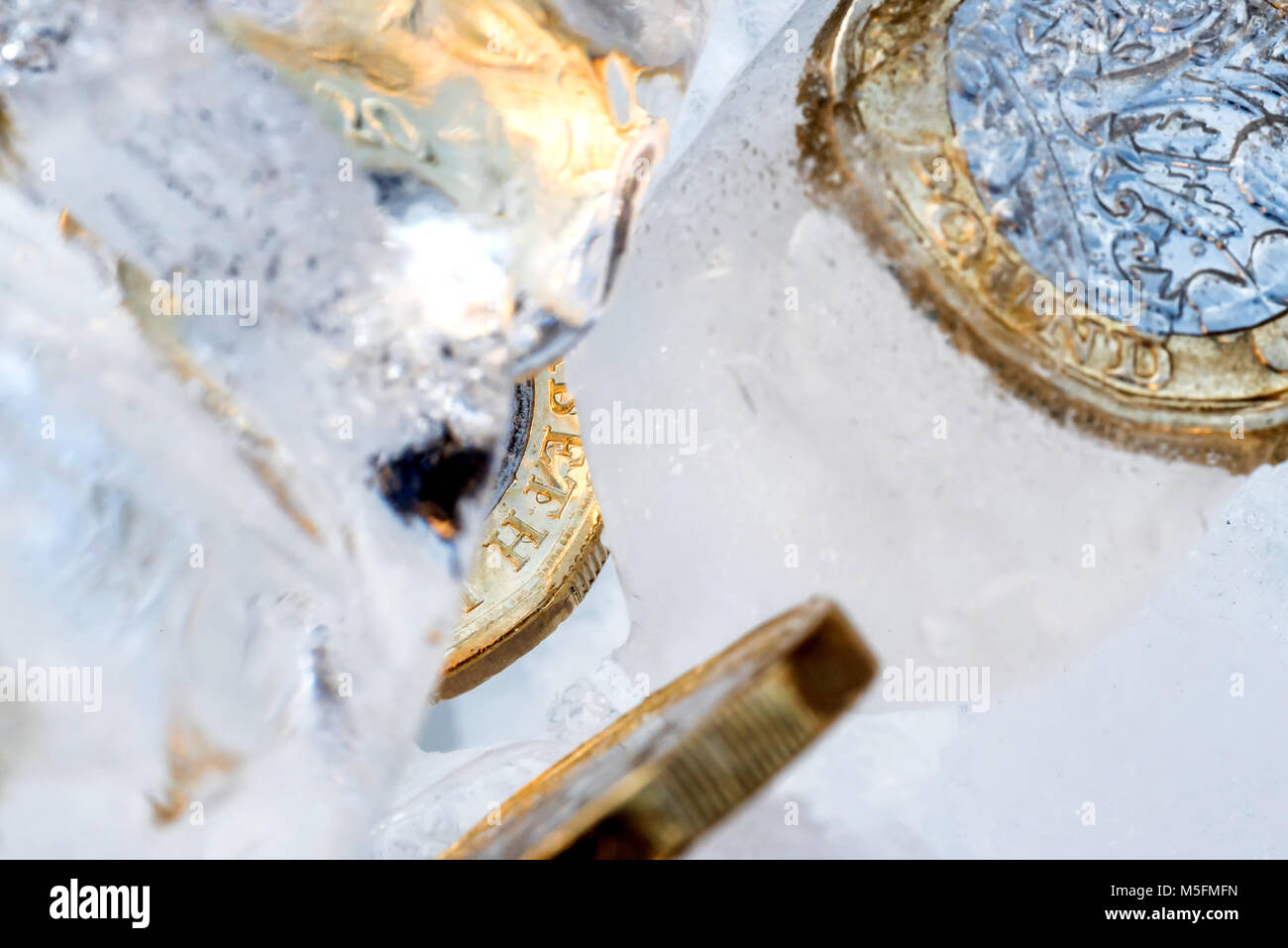 Frozen New British one pound sterling coin up close macro inside ice ...