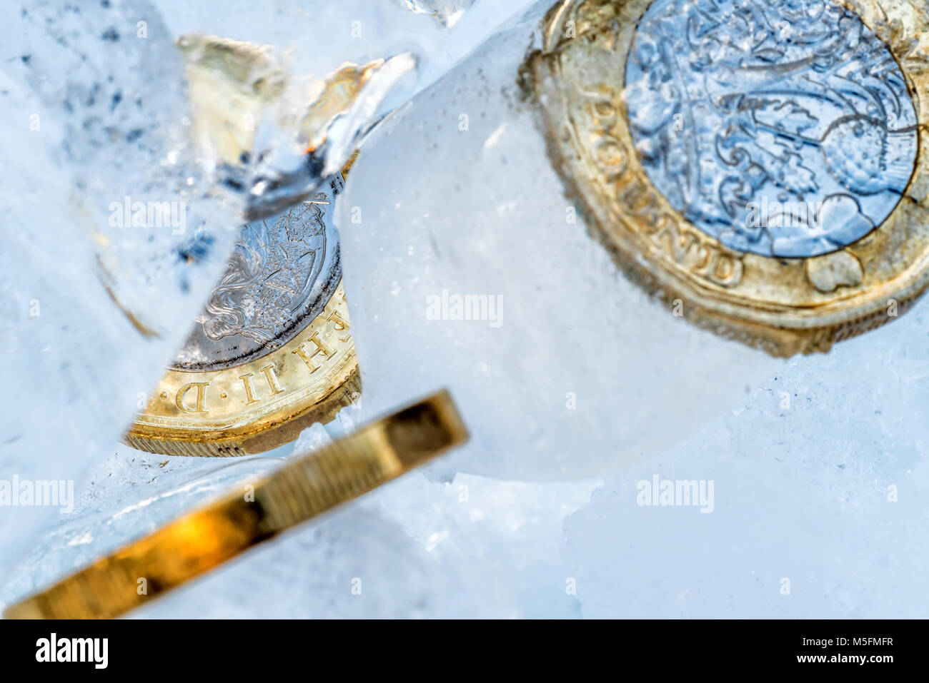 Frozen New British one pound sterling coin up close macro inside ice ...