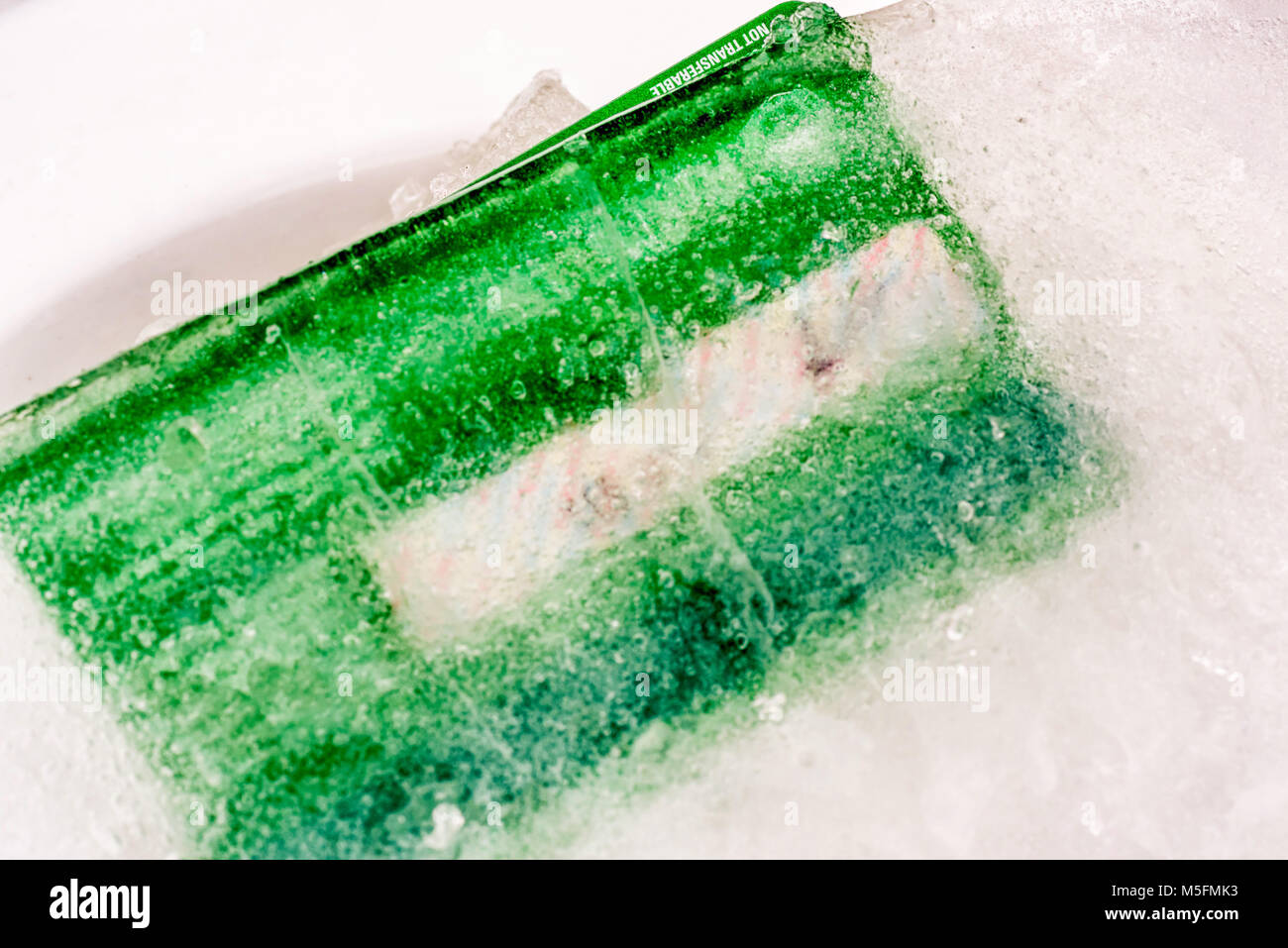 Closeup view ice frozen credit debit card Stock Photo - Alamy
