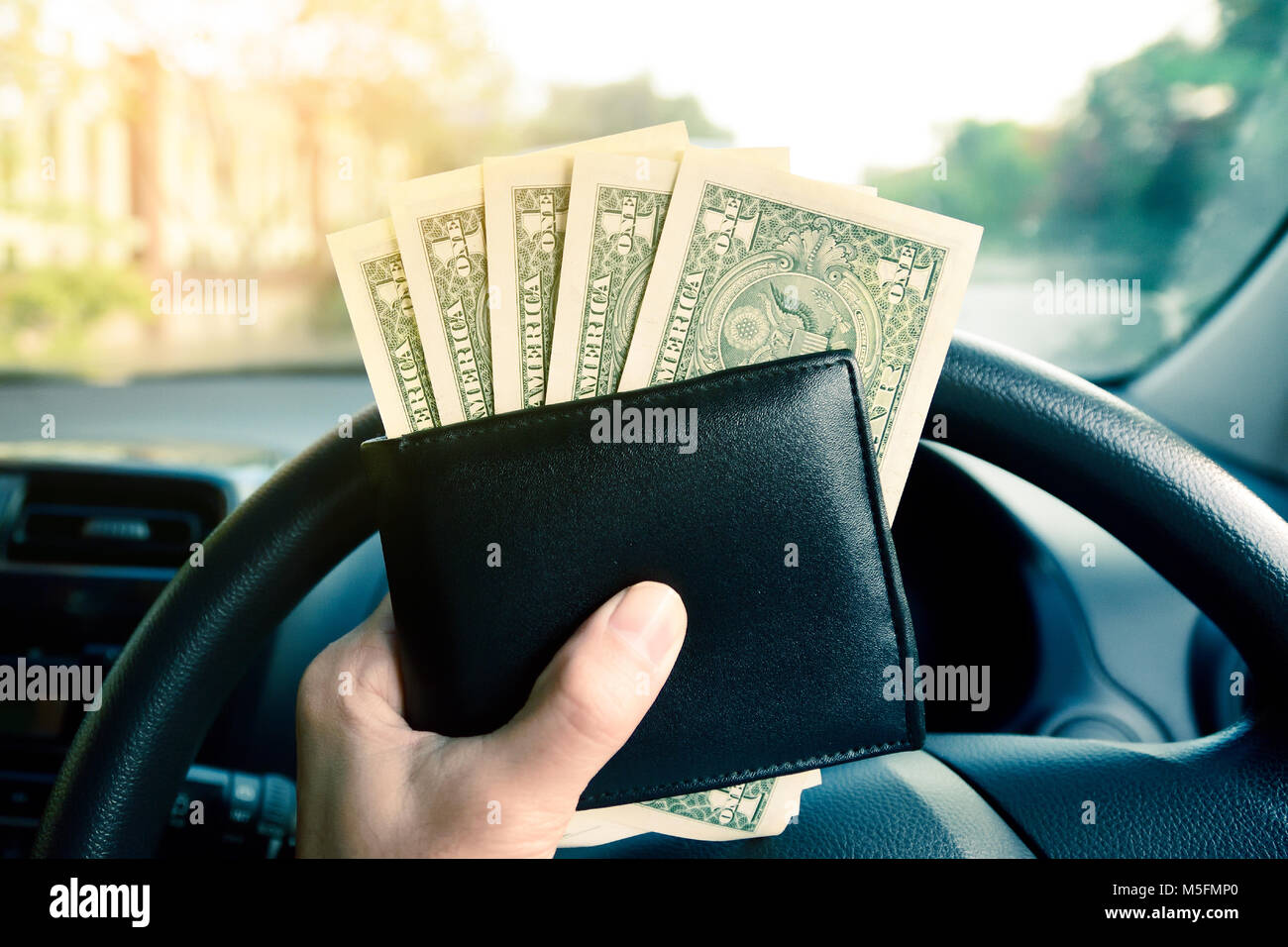 Hand holding dollar in car,Dollar money for use everyday Stock Photo ...
