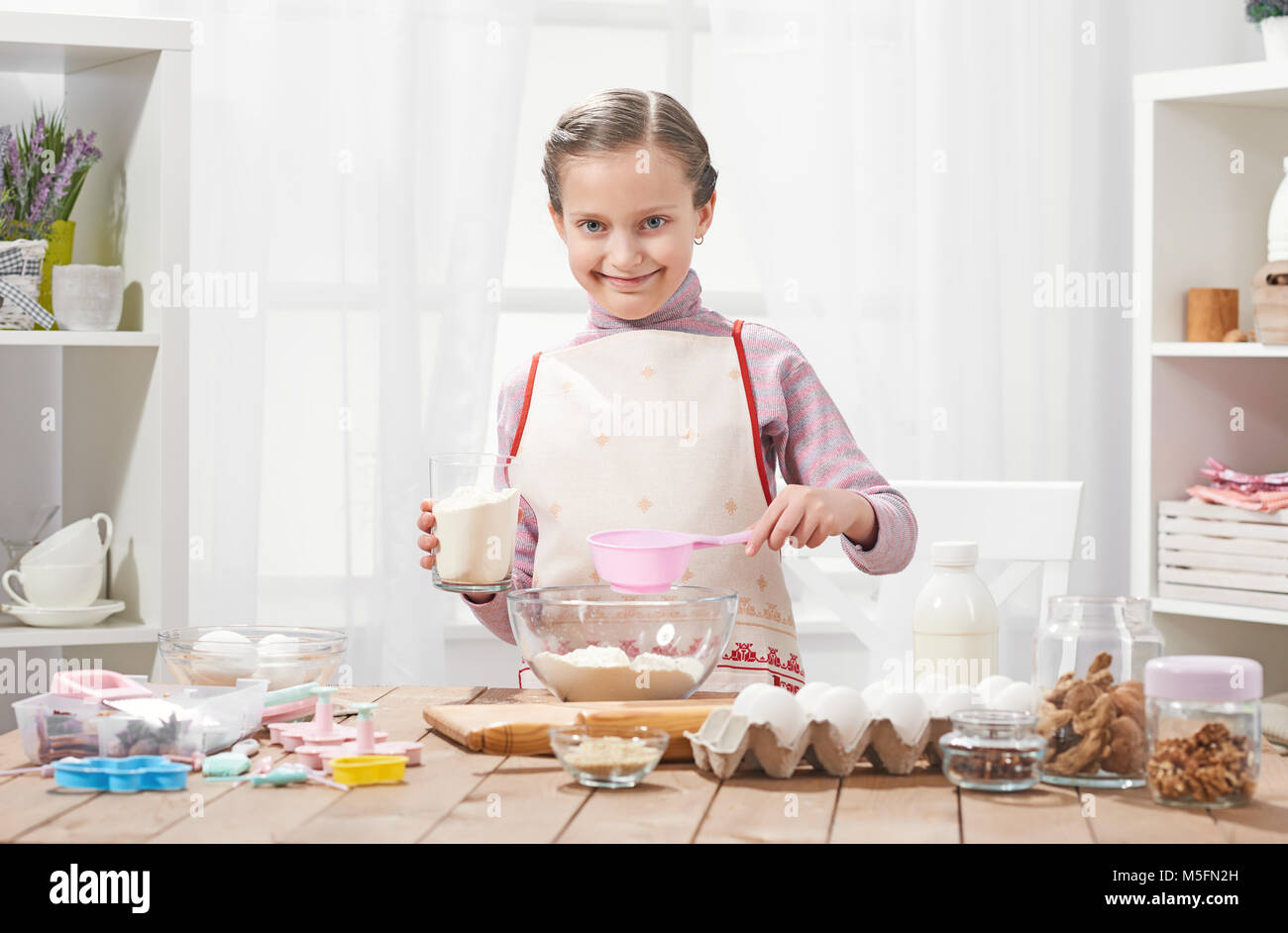 Girl cooking in home kitchen, making pastries, healthy food concept ...