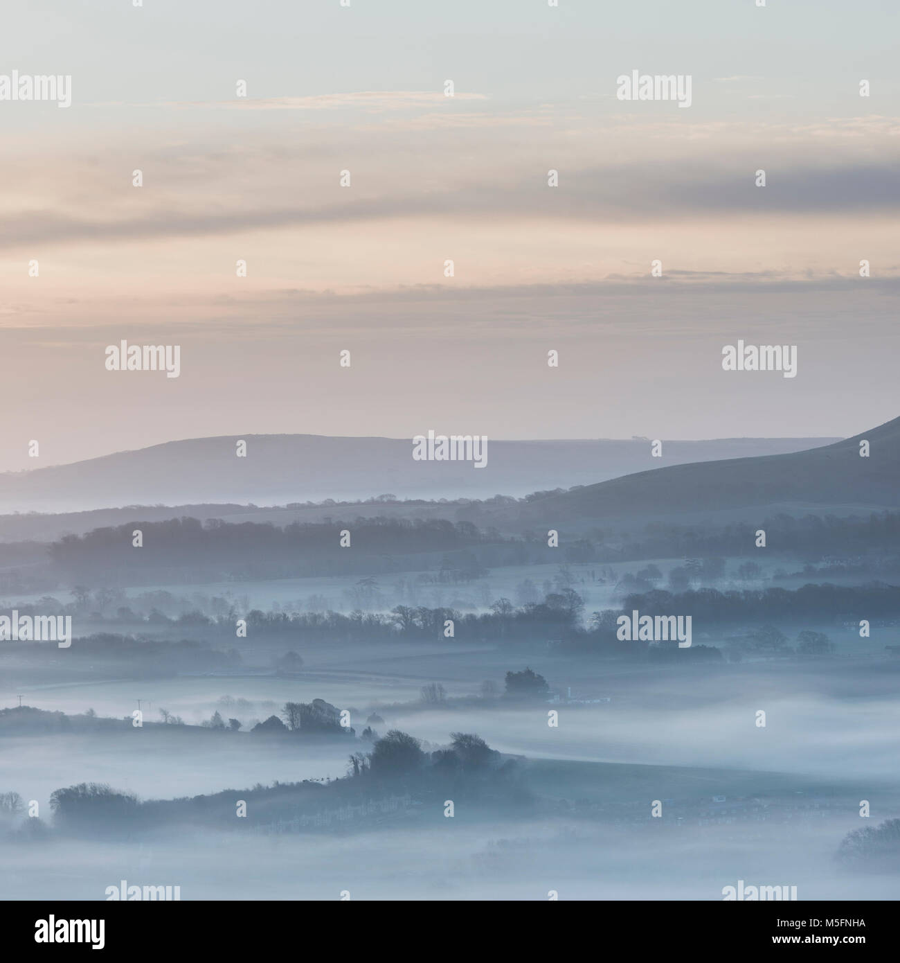 Beautiful foggy English countryside landscape at sunrise in Winter with ...