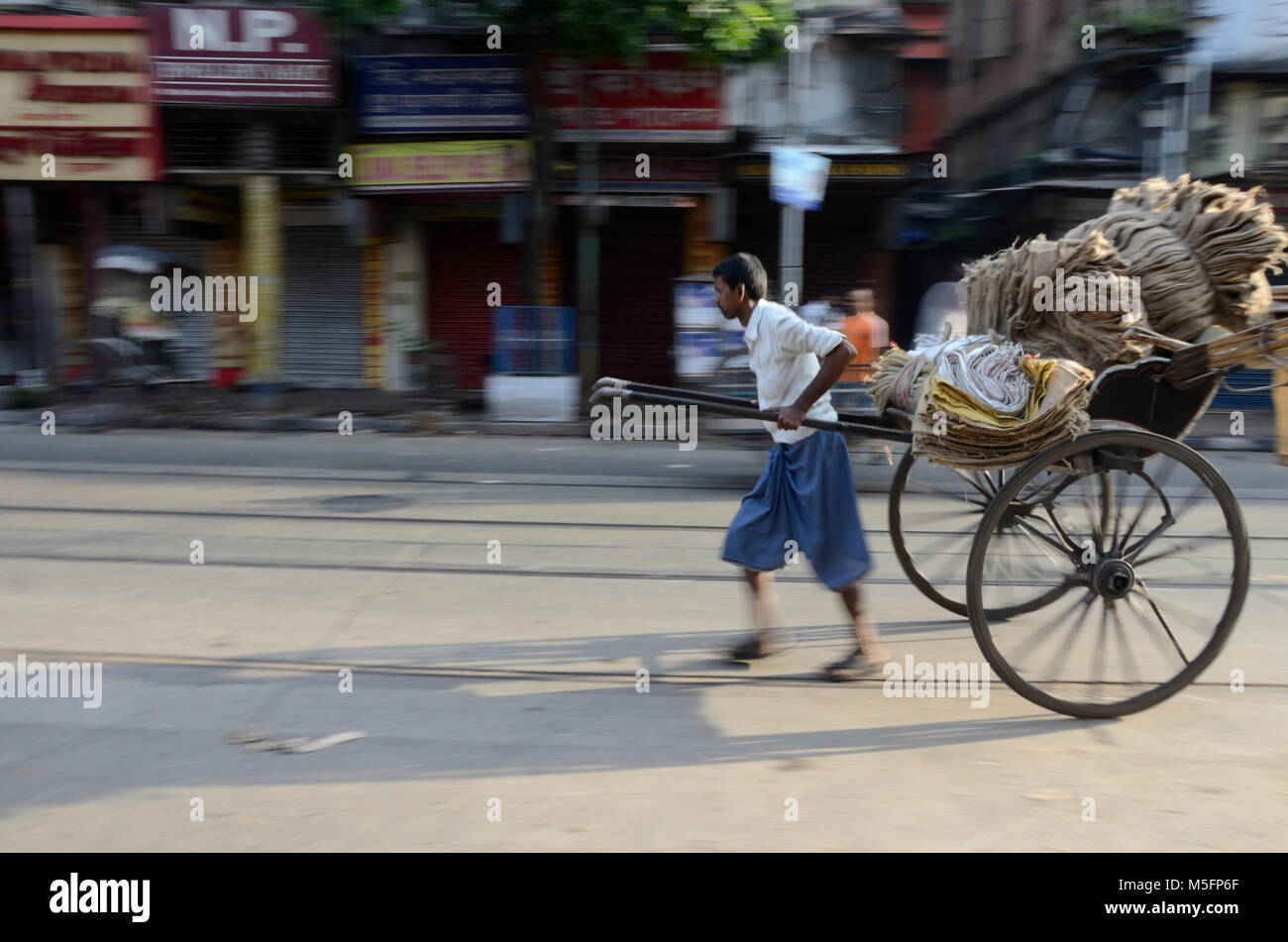 Man pulling rickshaw hi-res stock photography and images - Alamy