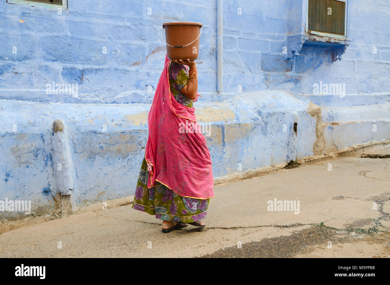 Woman with water bucket hi-res stock photography and images - Alamy