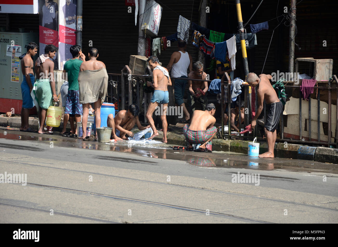 Indian man bathing washing clothes hi-res stock photography and images ...