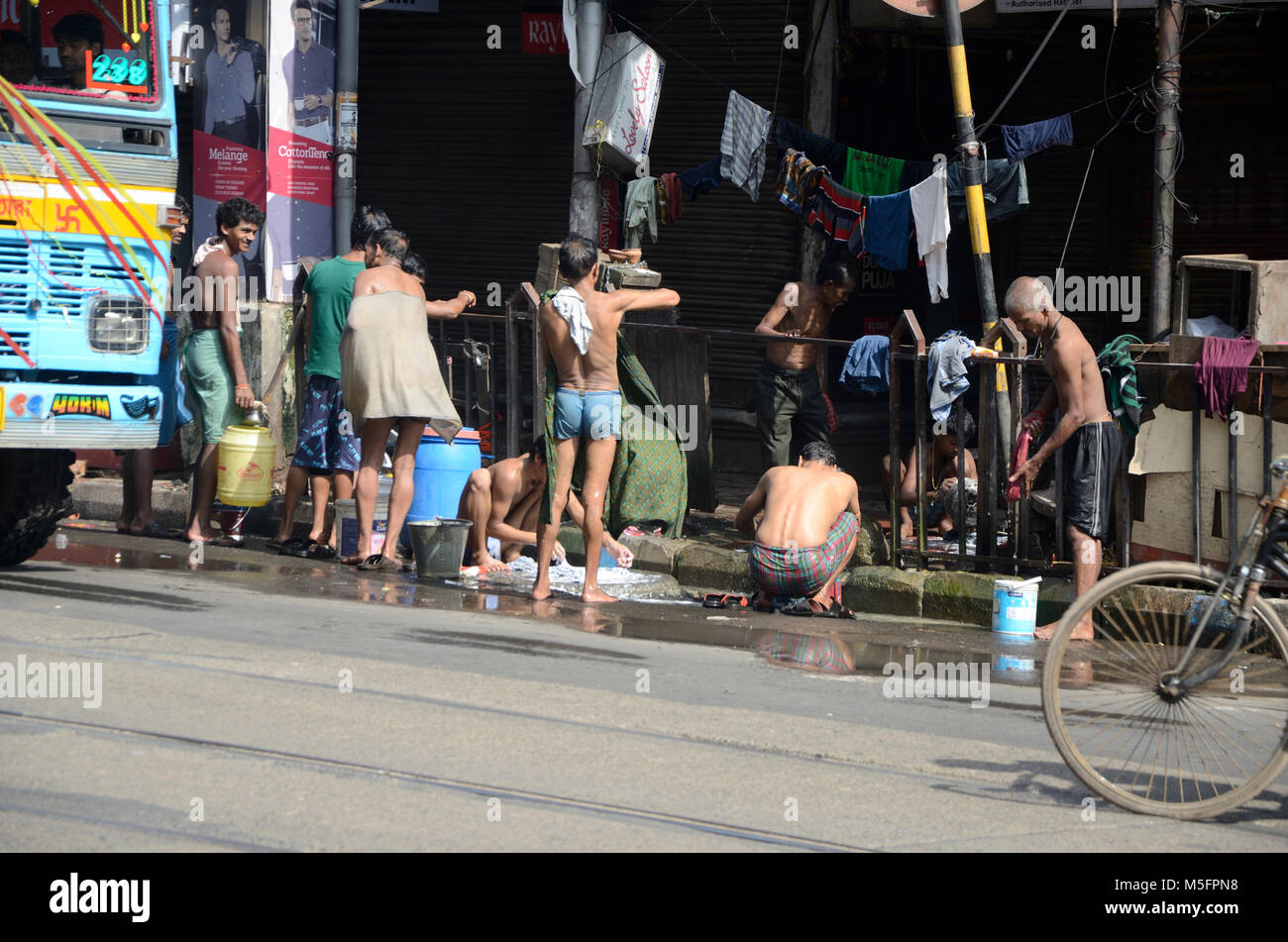 Indian man bathing washing clothes hi-res stock photography and images ...