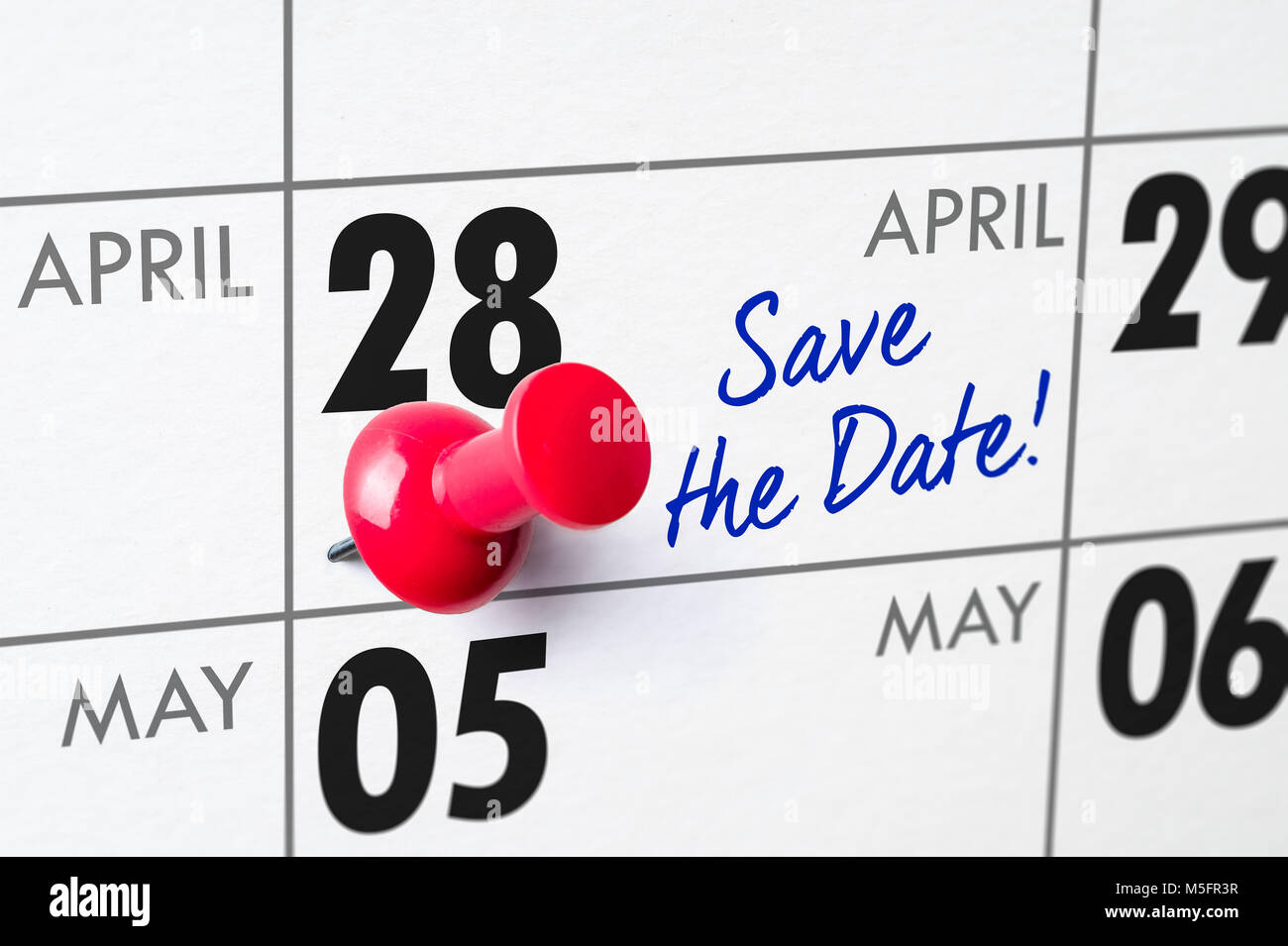 Wall calendar with a red pin - April 28 Stock Photo - Alamy