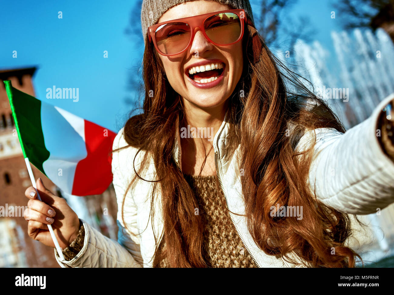 Rediscovering things everybody love in Milan. smiling modern woman in ...