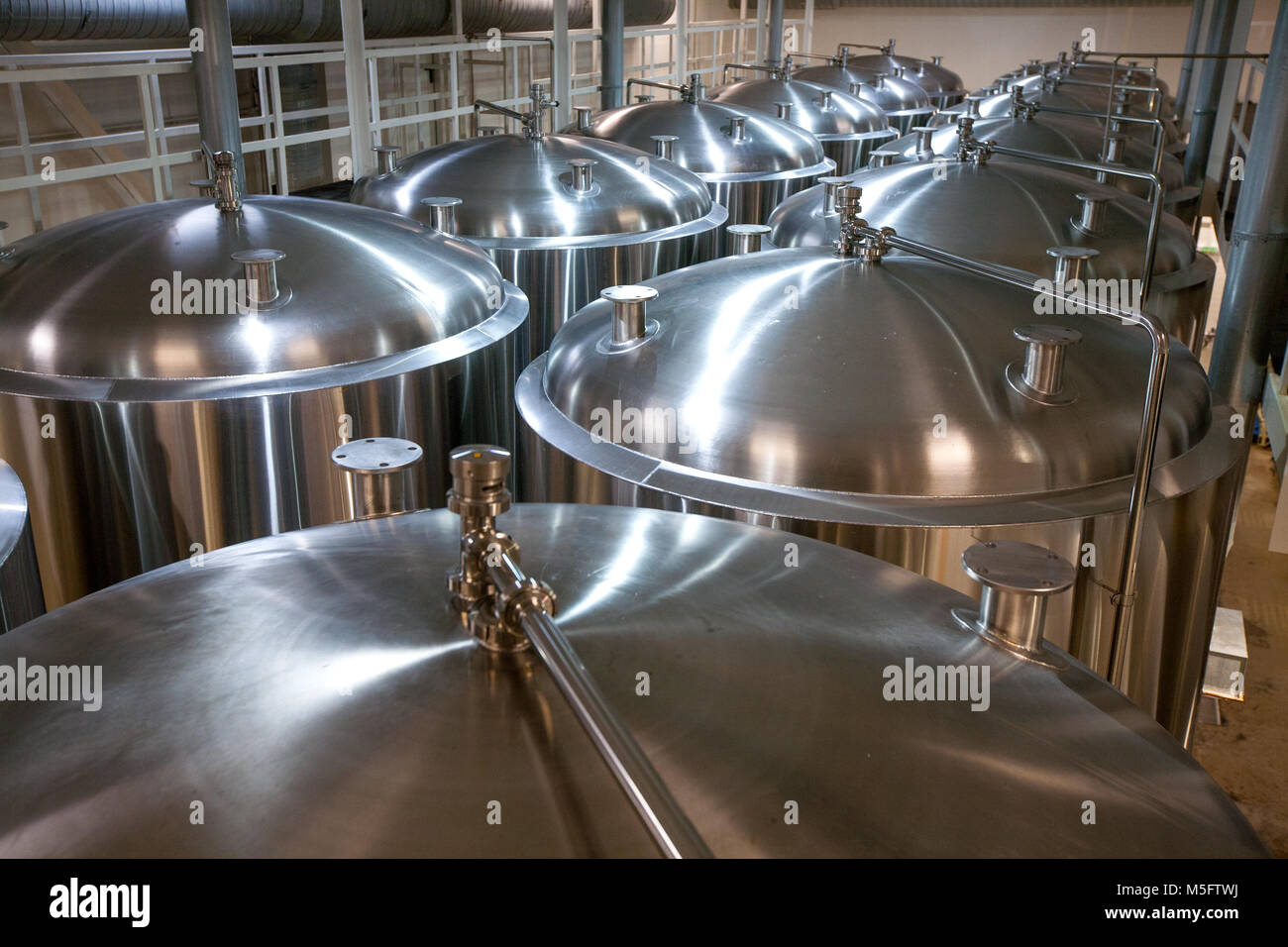 Huge Tanks of white metal, which brewed beer in the brewery, the top ...