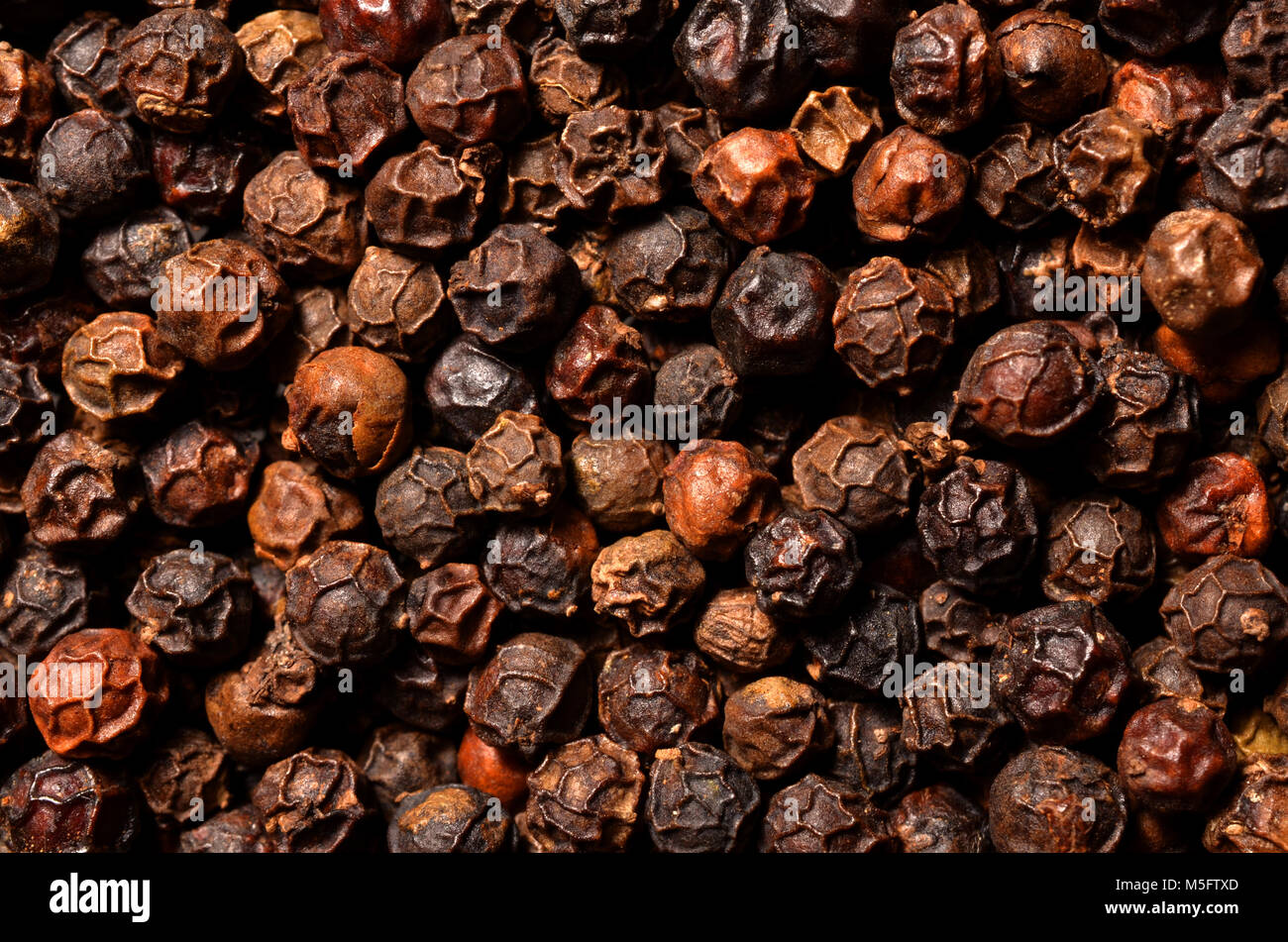 Dried black pepper grains texture, a close up photo image on surface of ...