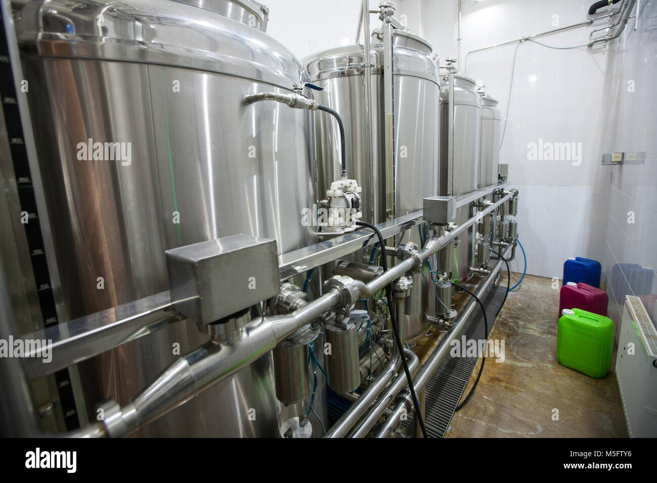 Huge Tanks of white metal, which brewed beer in the brewery, the top ...