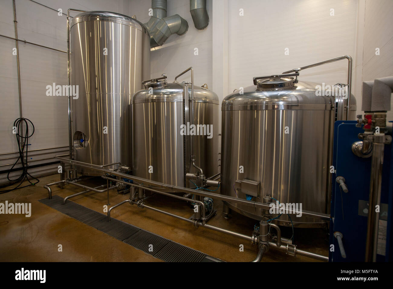 Huge Tanks of white metal, which brewed beer in the brewery, the top ...
