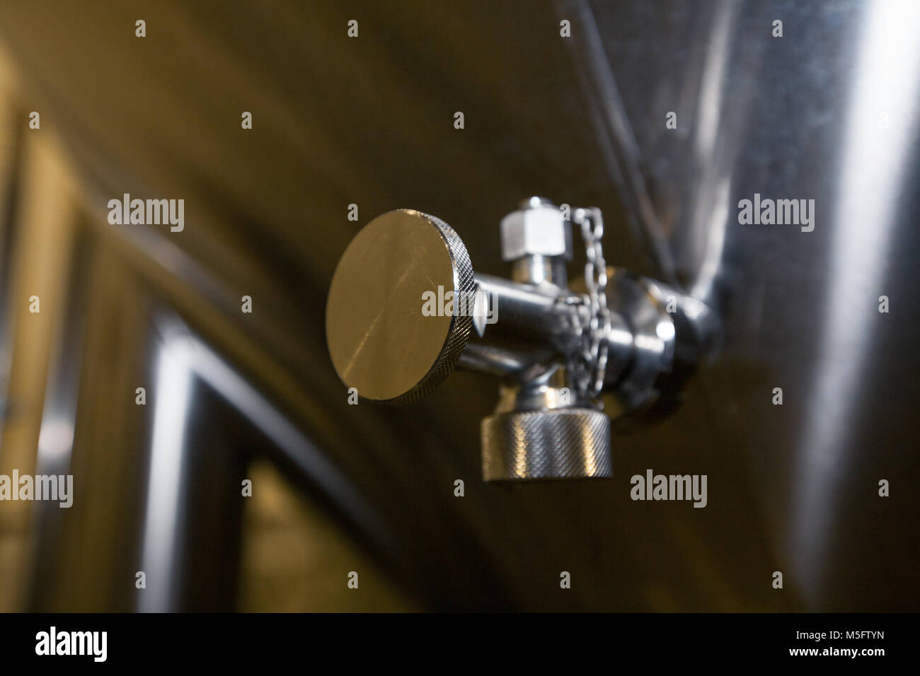 Valves and pipes made of white metal, located on the tanks, which ...